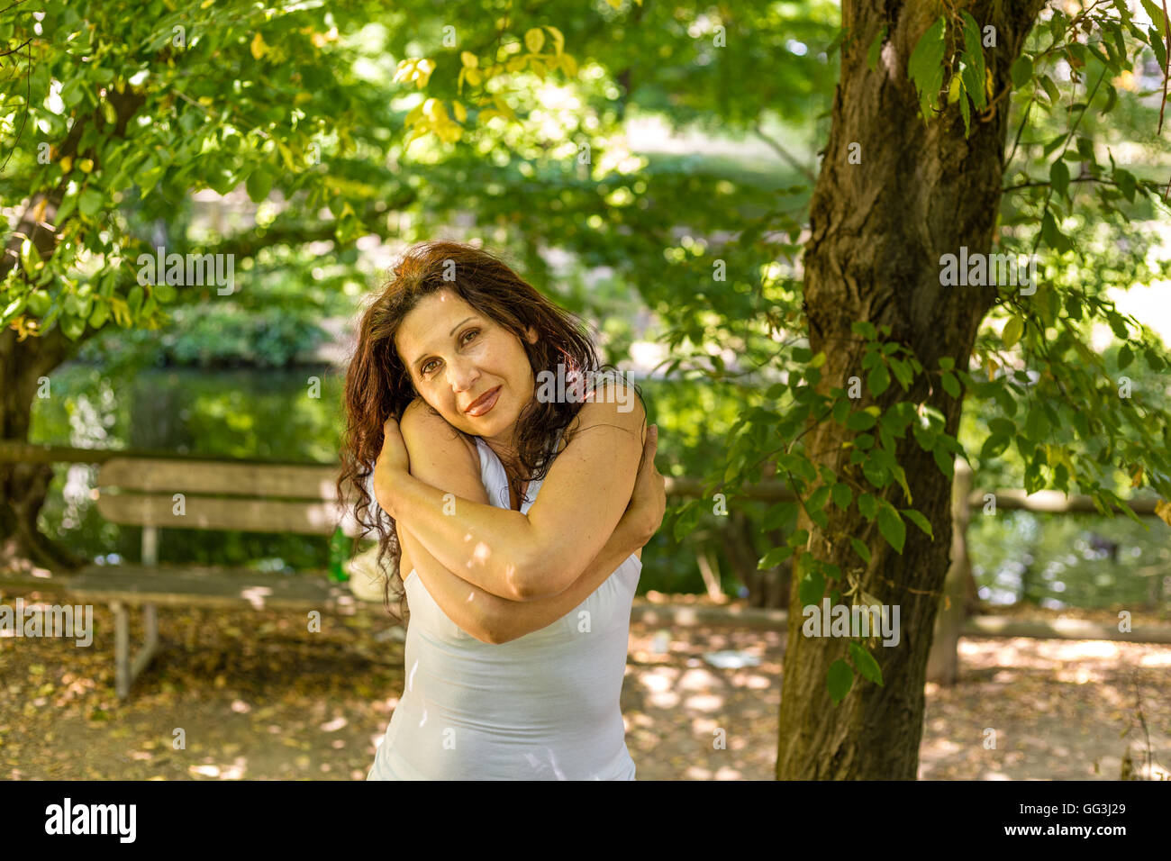 Mature woman hugging herself hi-res stock photography and images - Alamy