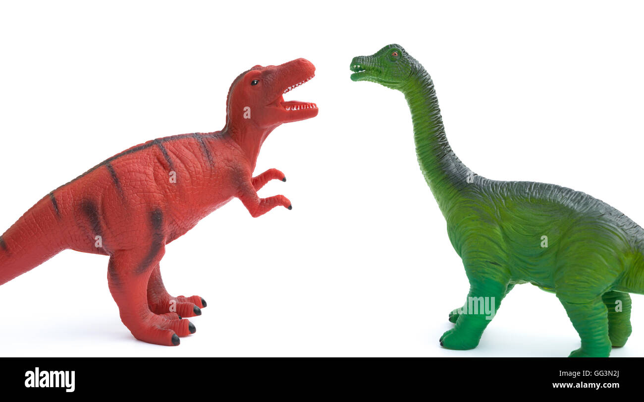green brachiosaurus and red tyrannosaurus toys on a white background ...