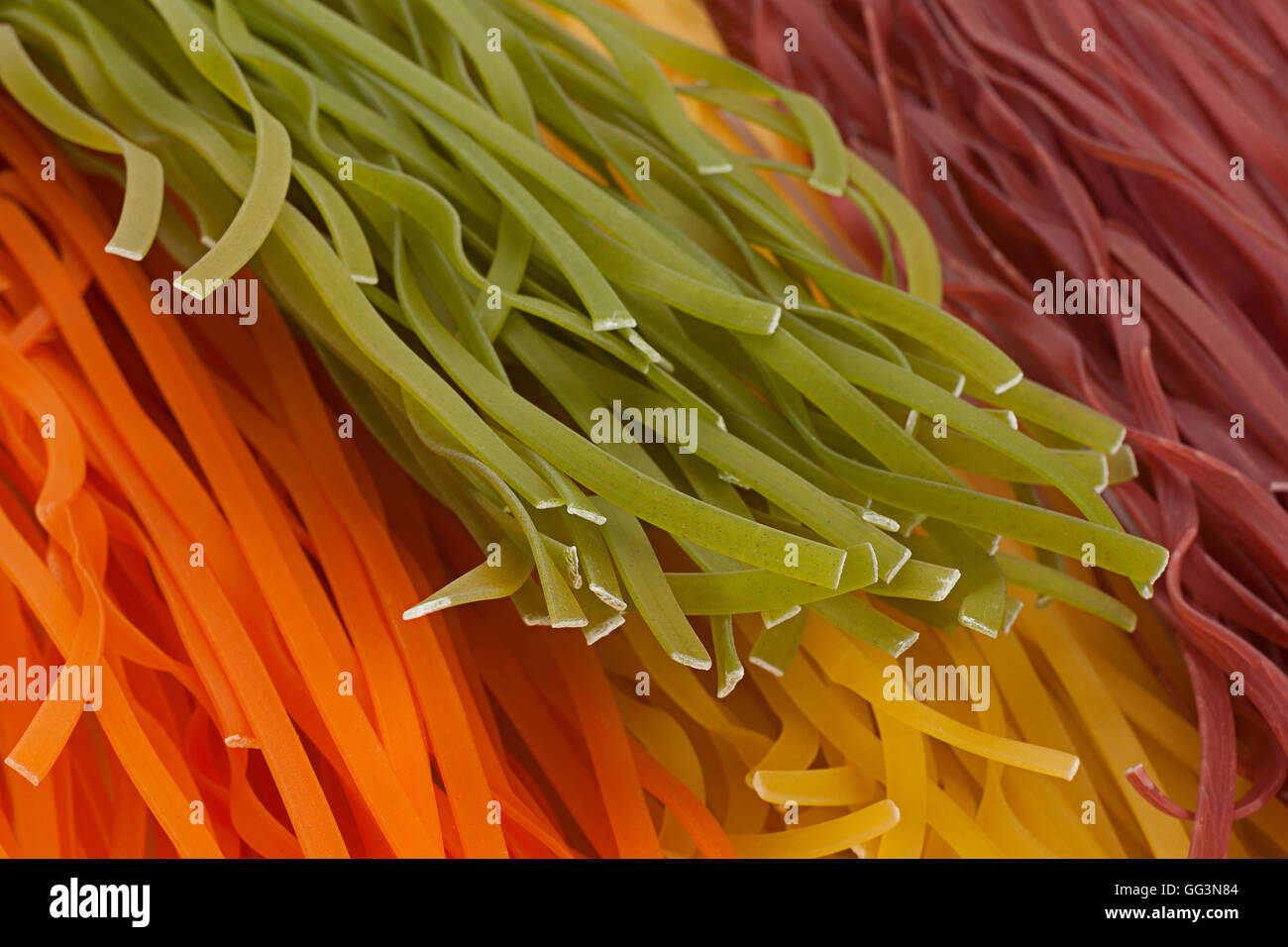 Wheat multicolored noodles closeup background Stock Photo - Alamy