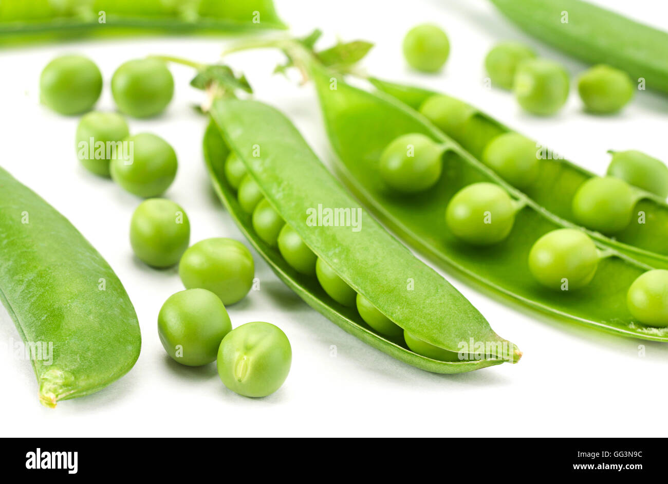 Young grean peas closeup isolated on white background Stock Photo - Alamy