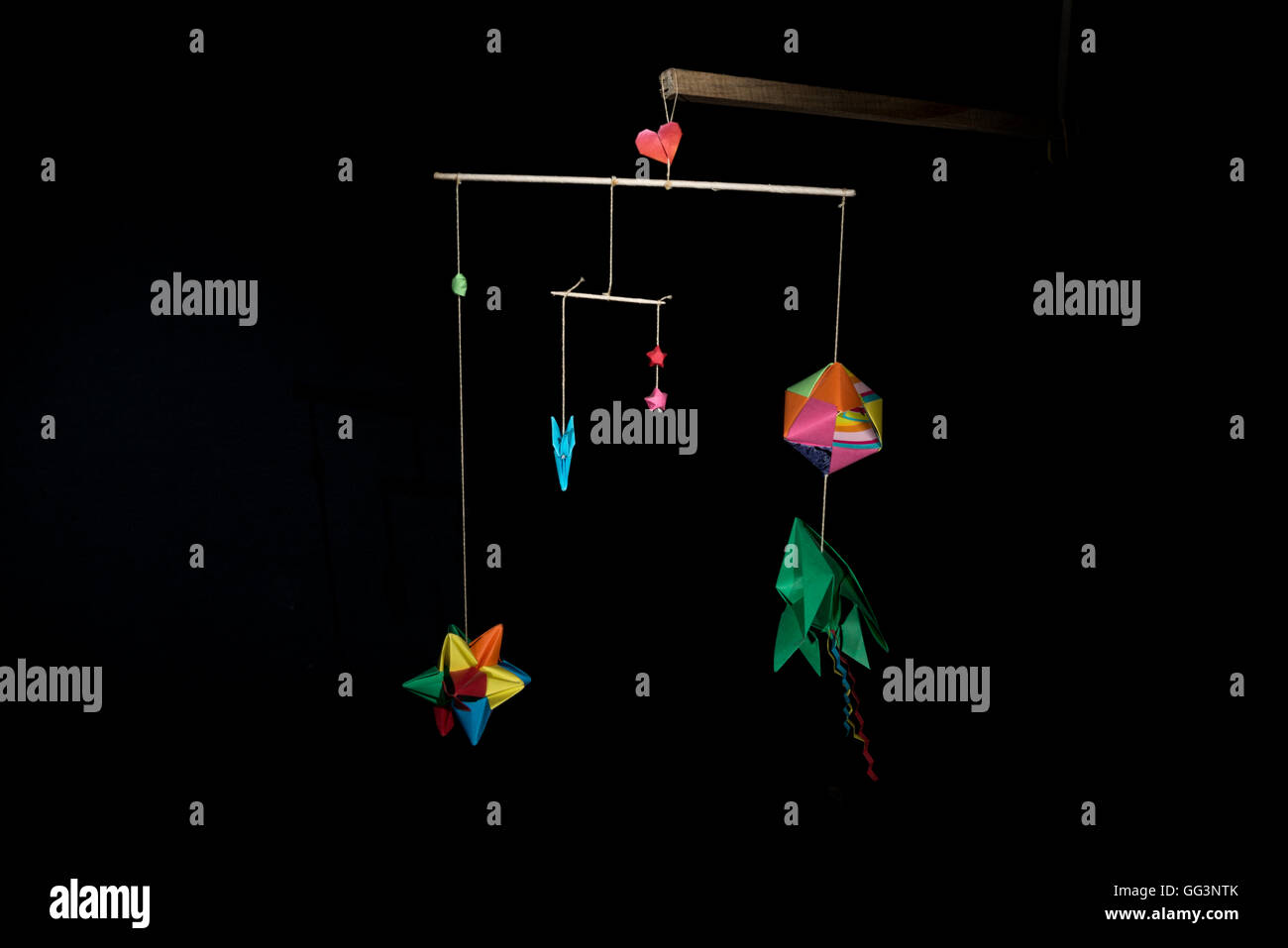origami mobile colored paper on black background Stock Photo - Alamy