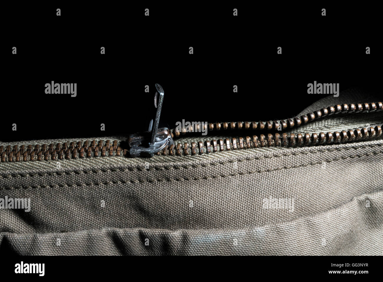 metal zipper closing hard cloth on black background Stock Photo - Alamy