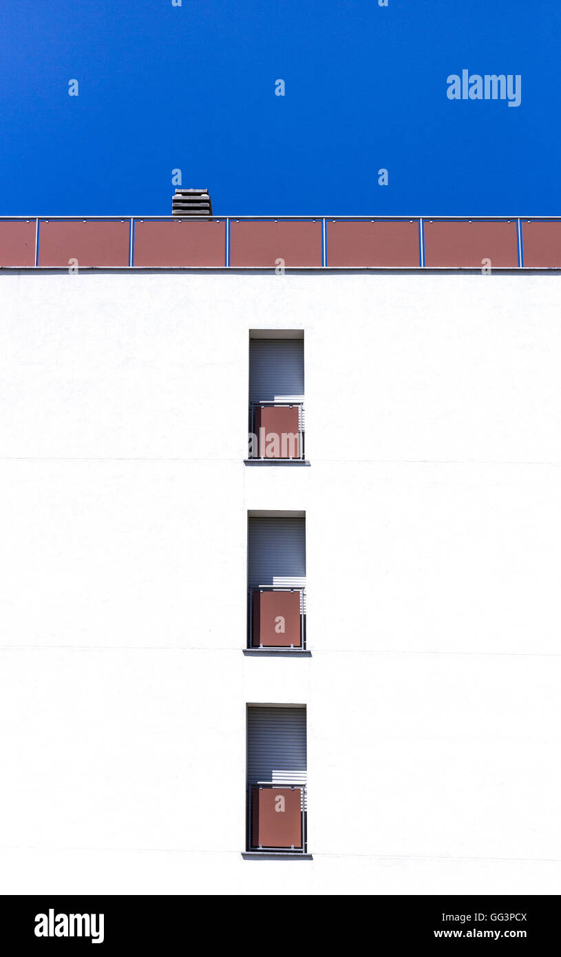 Facade of a modern building with three windows Stock Photo - Alamy