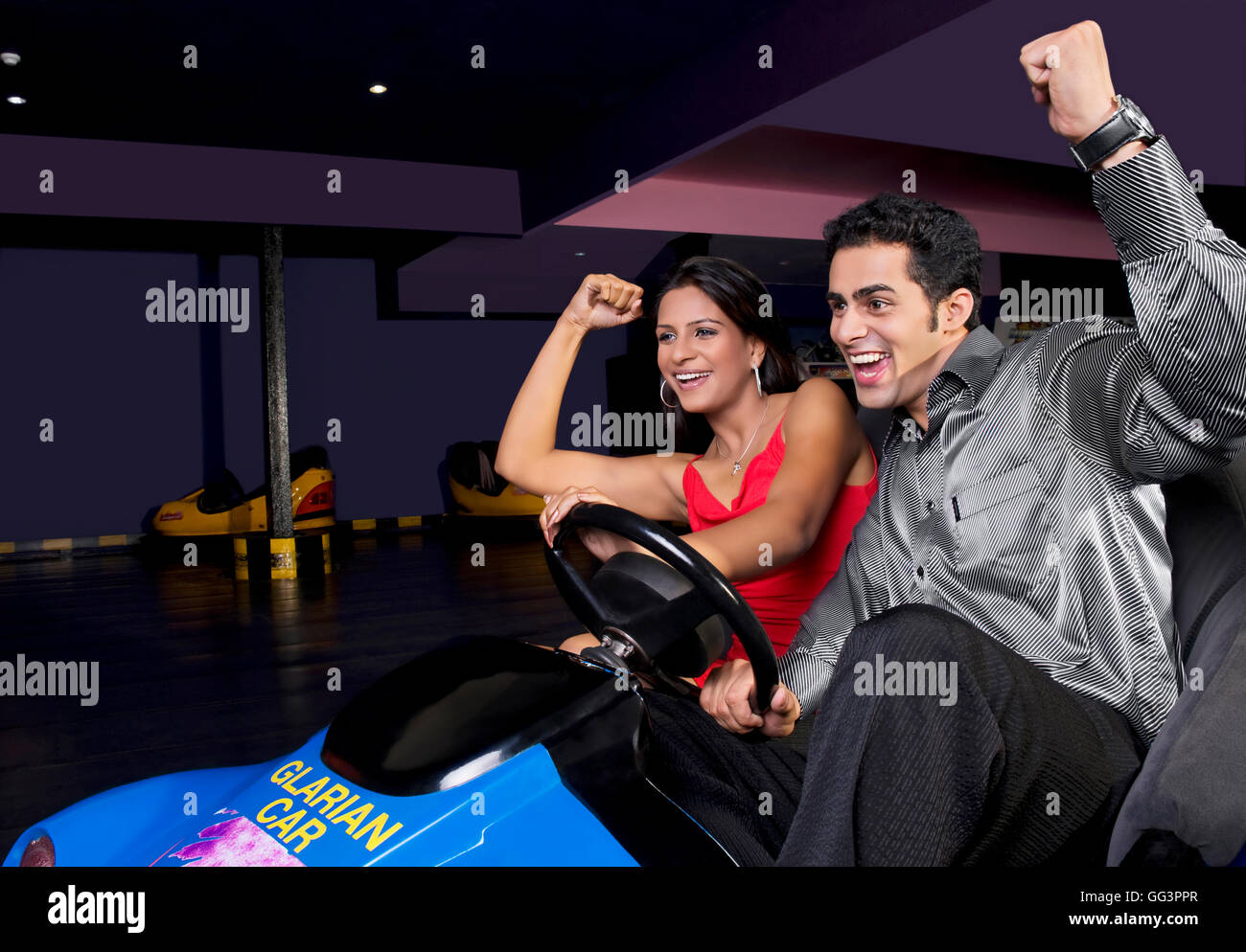 Having fun in bumper cars Stock Photo - Alamy