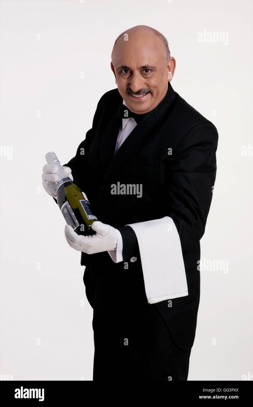 Butler holding a bottle Stock Photo - Alamy