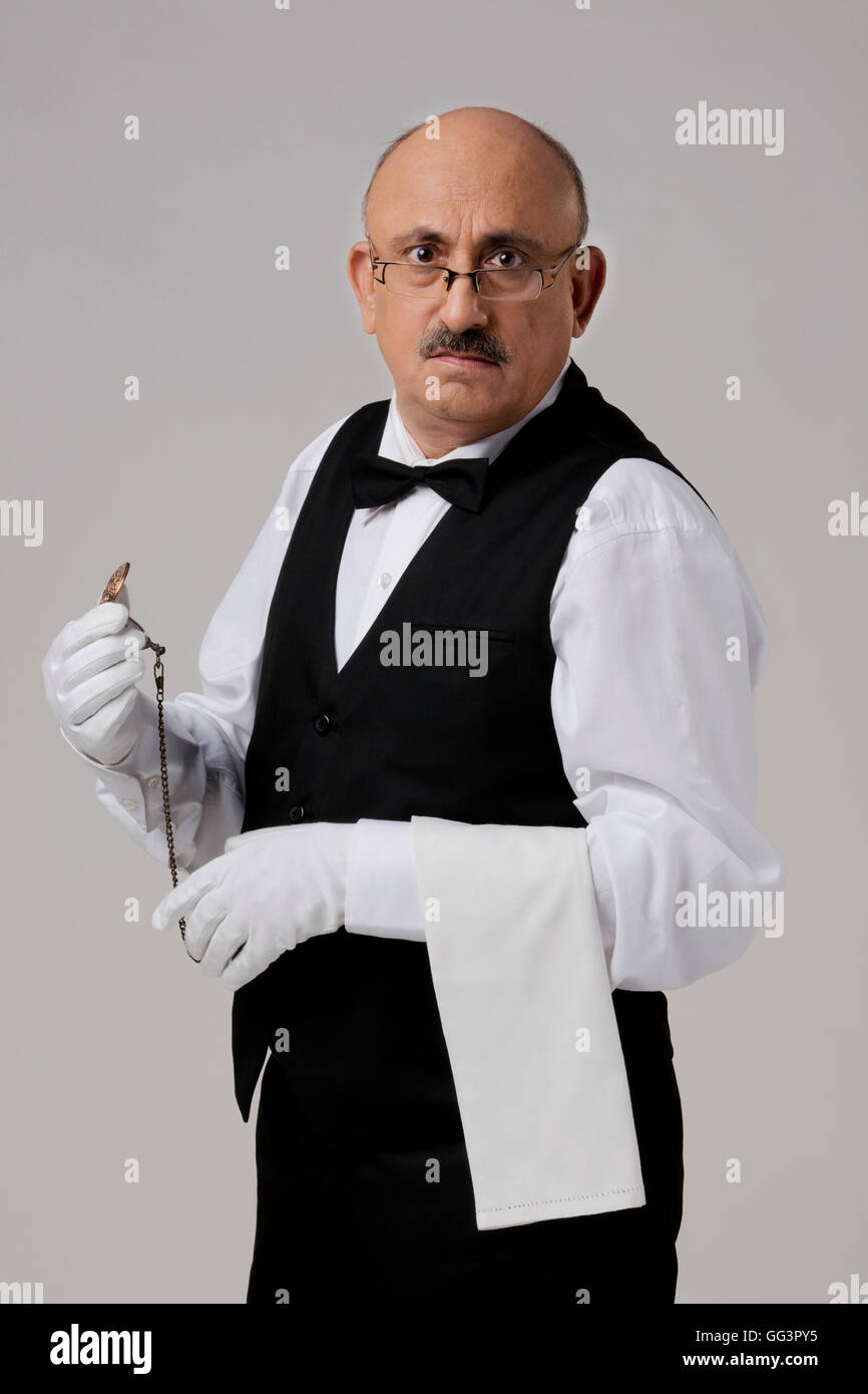 Butler with a pocket watch Stock Photo - Alamy