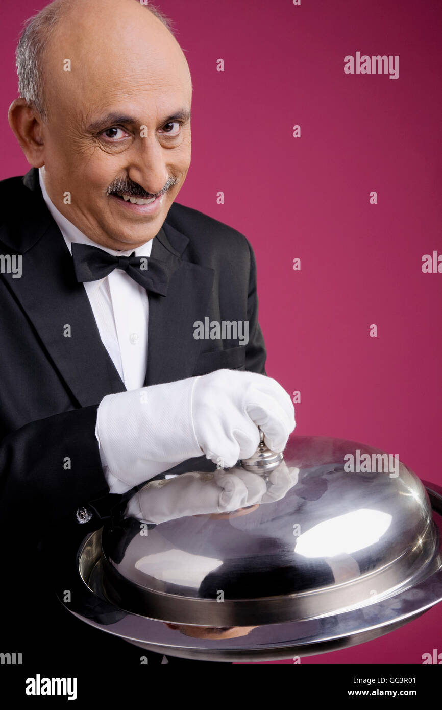 Butler with serving platter Stock Photo - Alamy