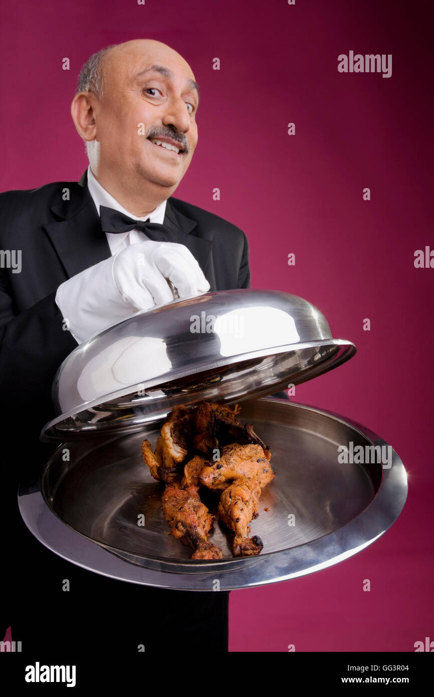 Butler serving food hi-res stock photography and images - Alamy