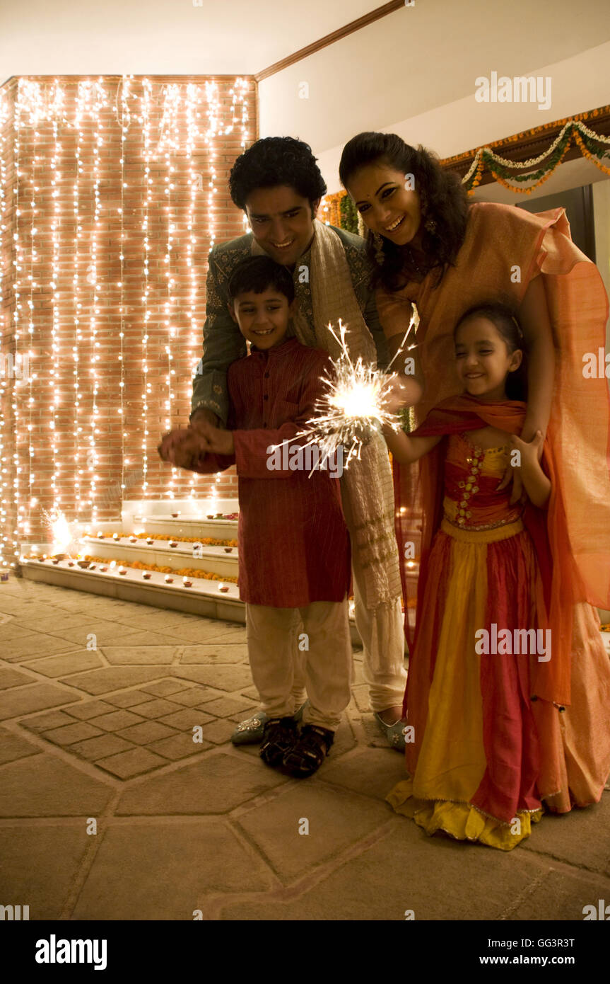 Family playing with firecrackers Stock Photo - Alamy