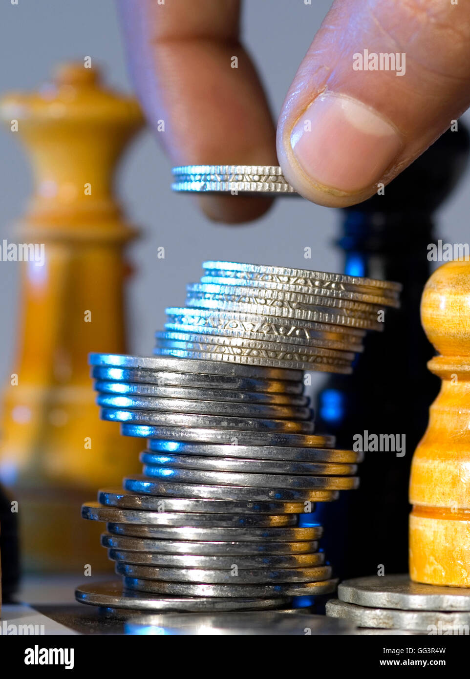 Man stacking coins Stock Photo - Alamy