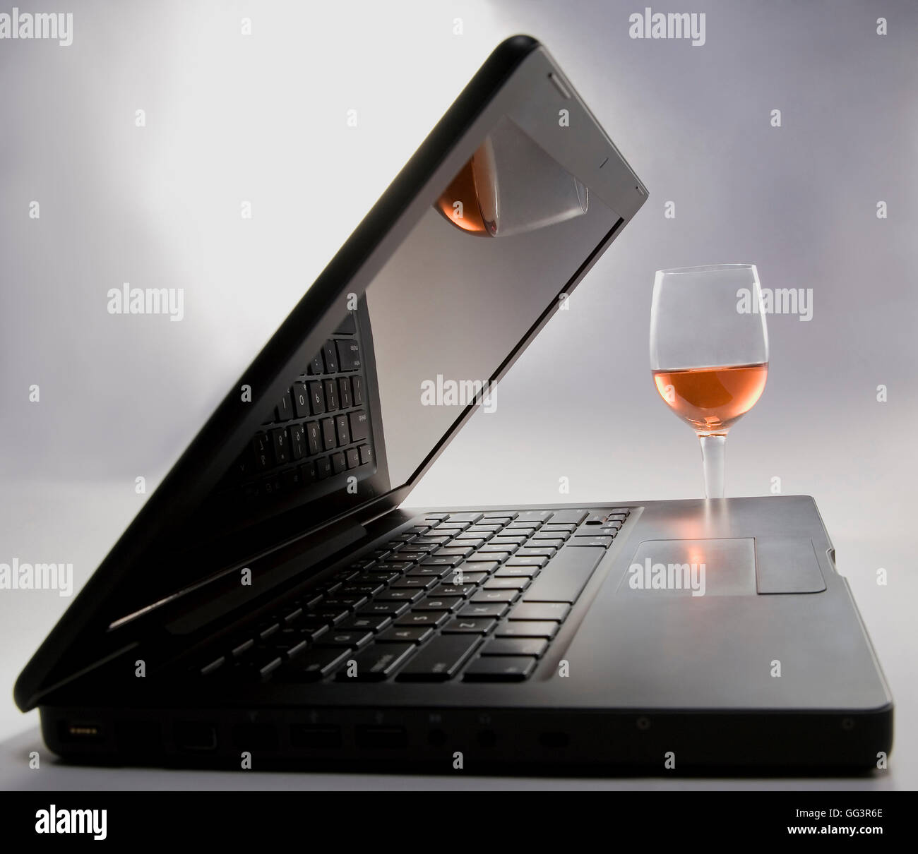 A laptop and a glass Stock Photo - Alamy