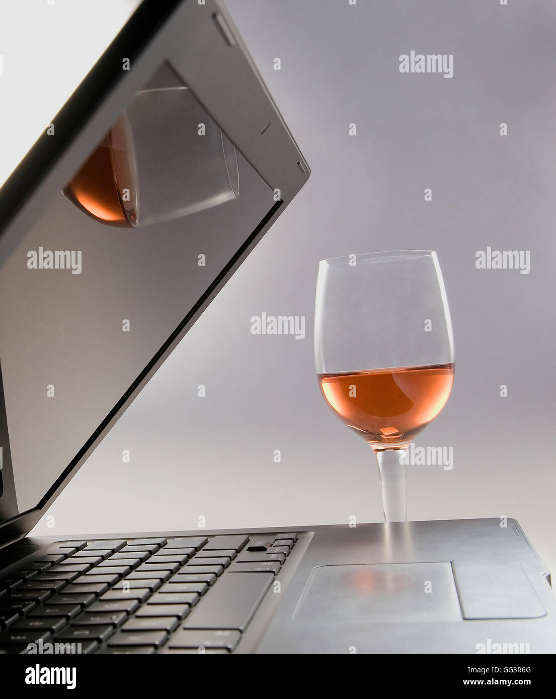 A laptop and a glass Stock Photo - Alamy