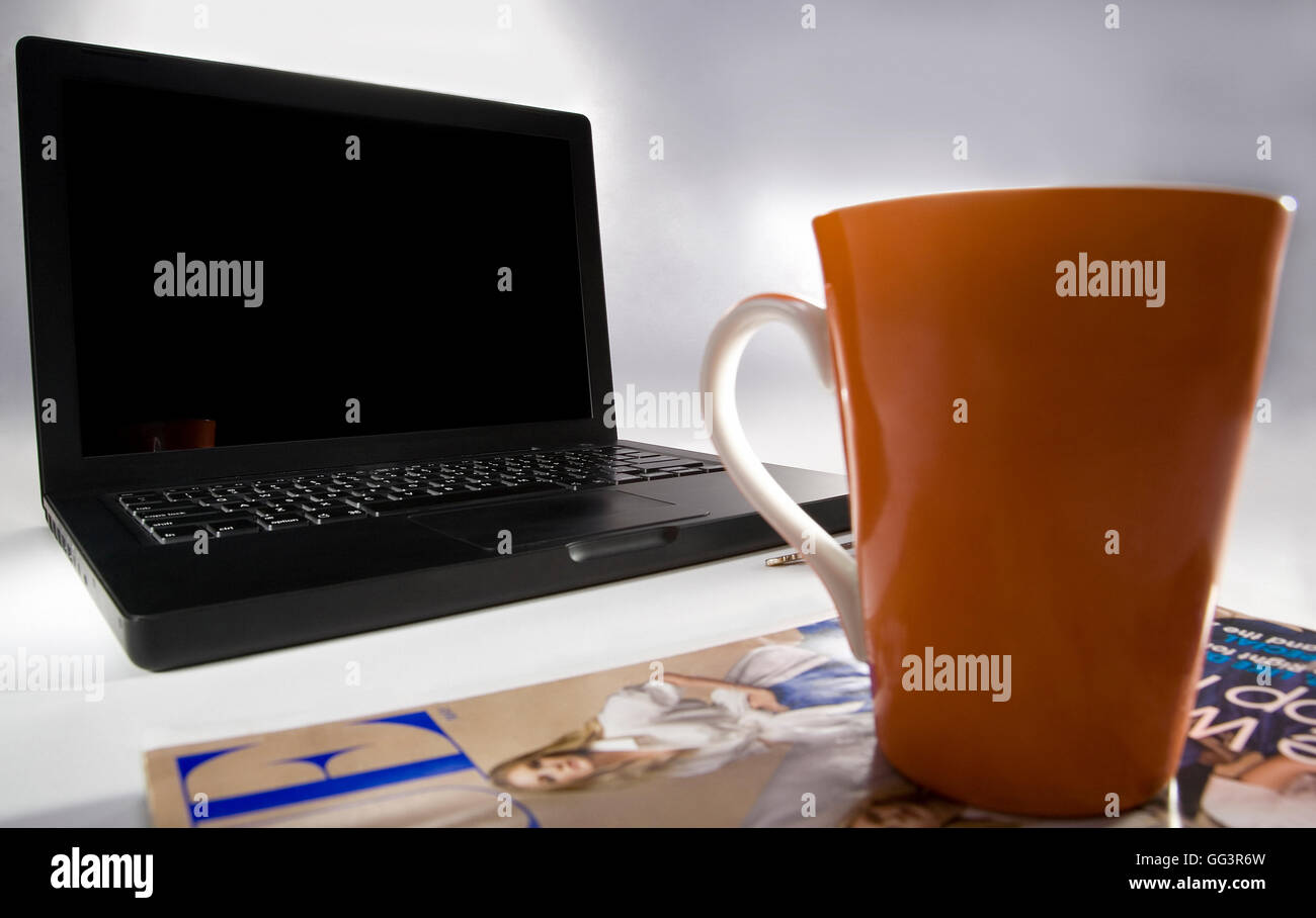 A laptop and a cup Stock Photo - Alamy