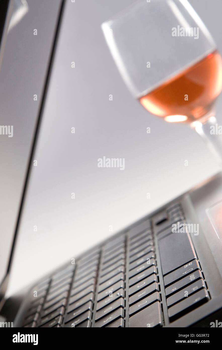 A laptop and a glass Stock Photo - Alamy