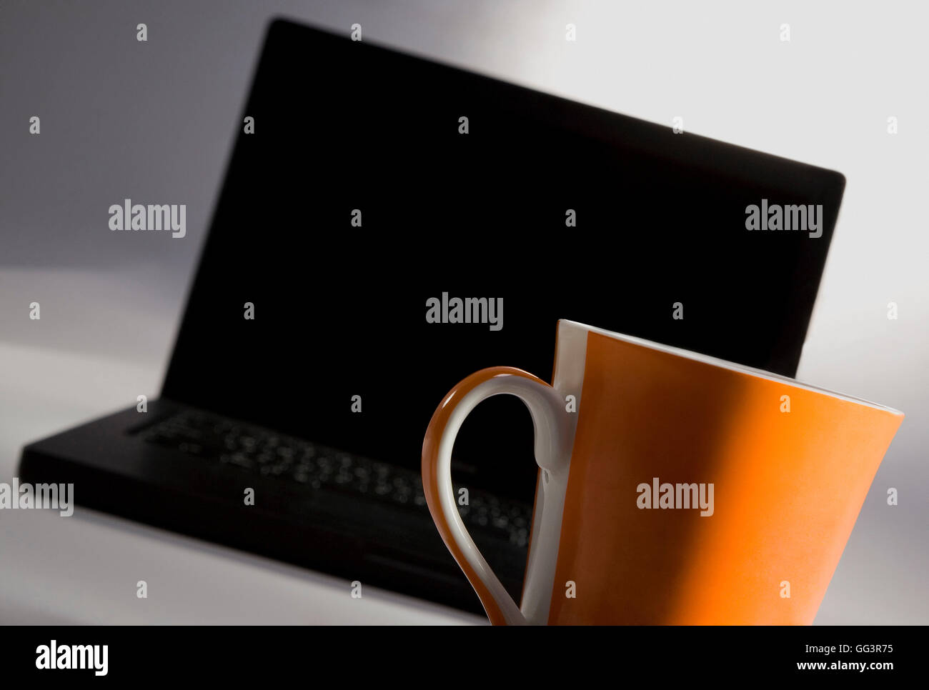 A laptop and a cup Stock Photo - Alamy