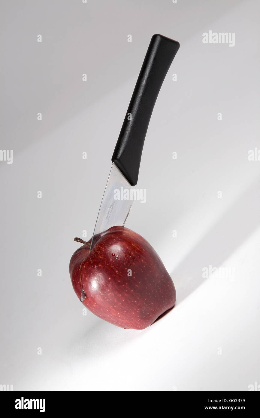 Apple with a knife Stock Photo - Alamy