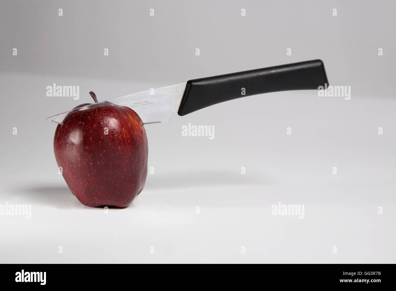 Apple with a knife Stock Photo - Alamy