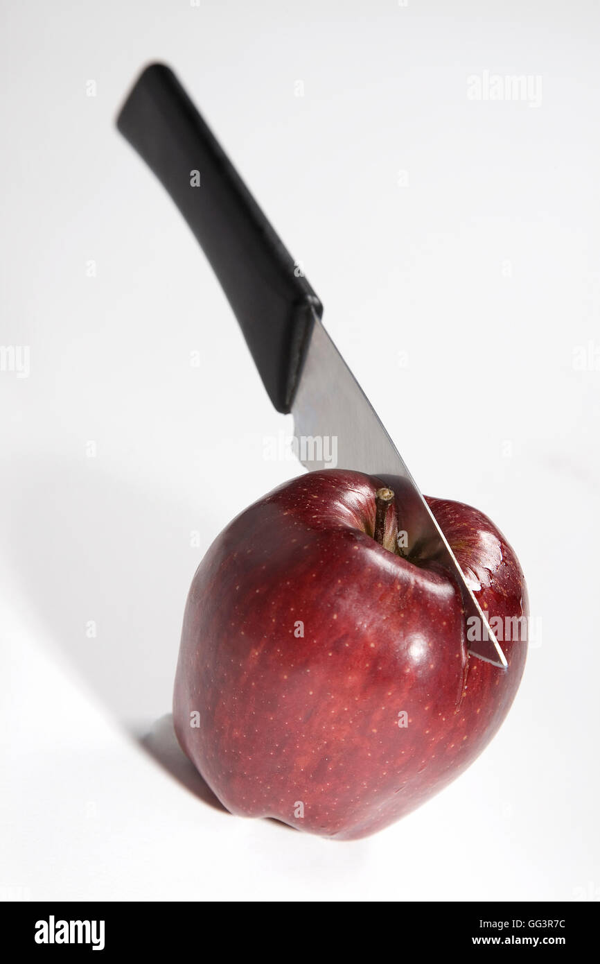 Apple with a knife Stock Photo - Alamy
