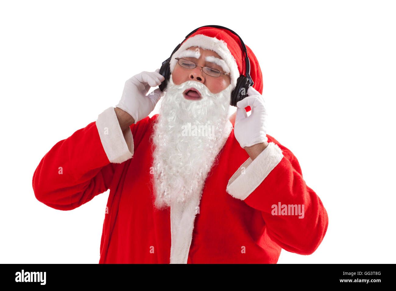 Santa Claus listening to music from headphones over white background ...
