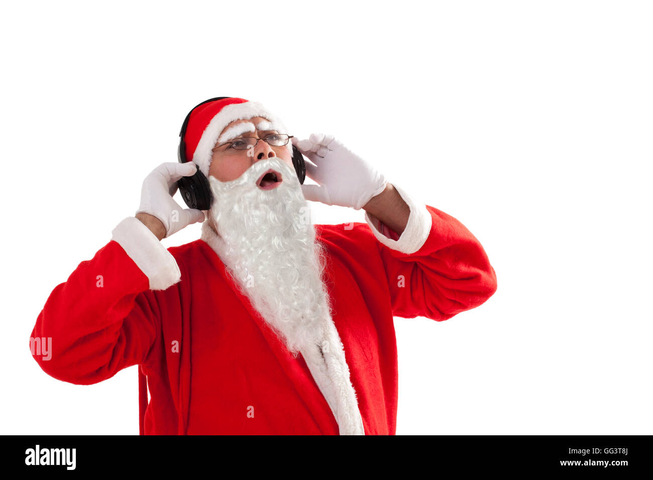Santa Claus listening to music over white background Stock Photo - Alamy