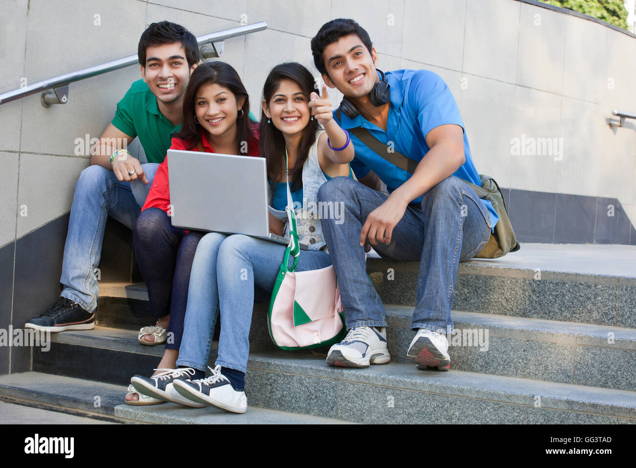 College students with laptop looking away Stock Photo - Alamy