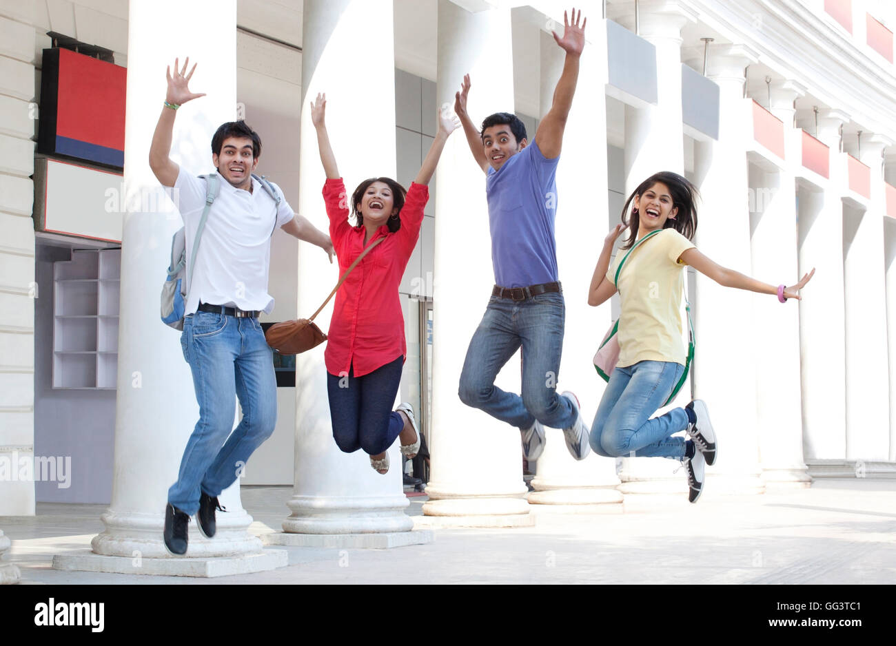 College students jumping with building in the background Stock Photo ...