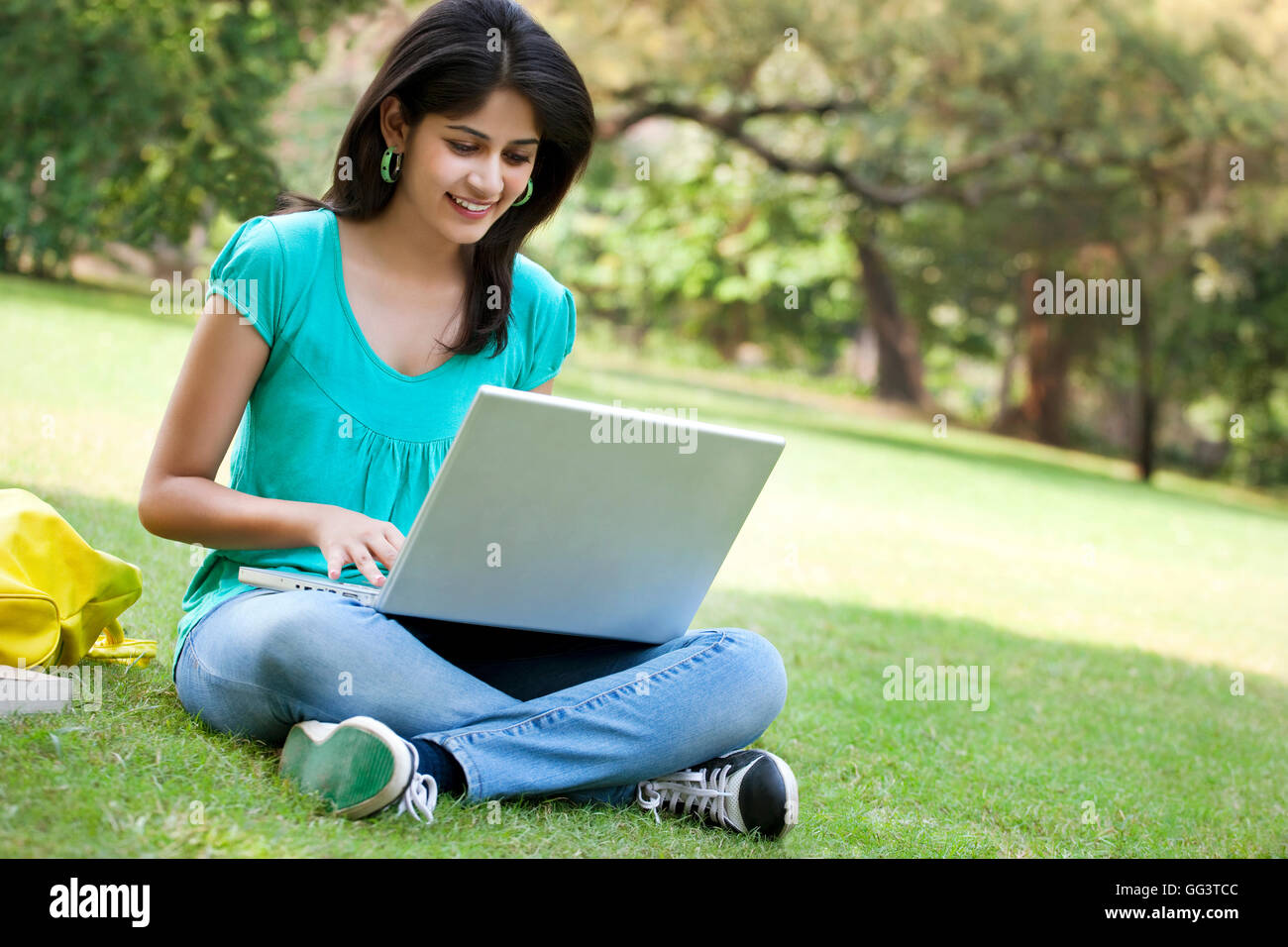 Young college student using laptop Stock Photo - Alamy