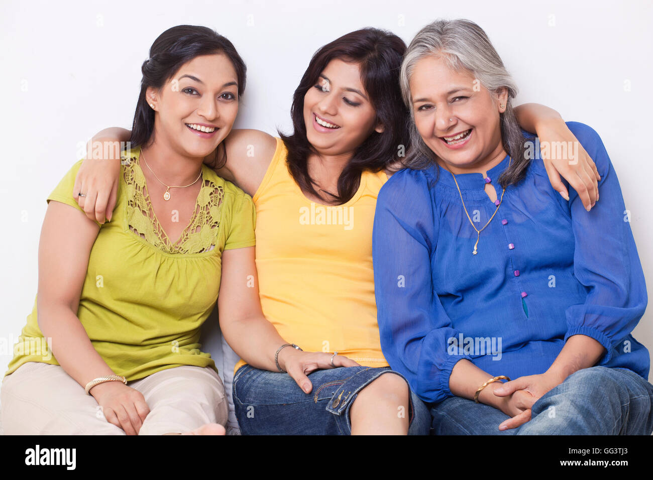Portrait of three generation family sitting together Stock Photo - Alamy