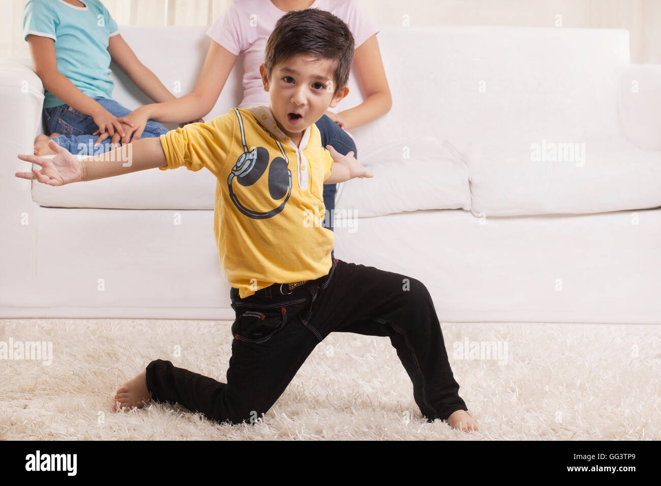 Little boy dancing with family in the background Stock Photo - Alamy