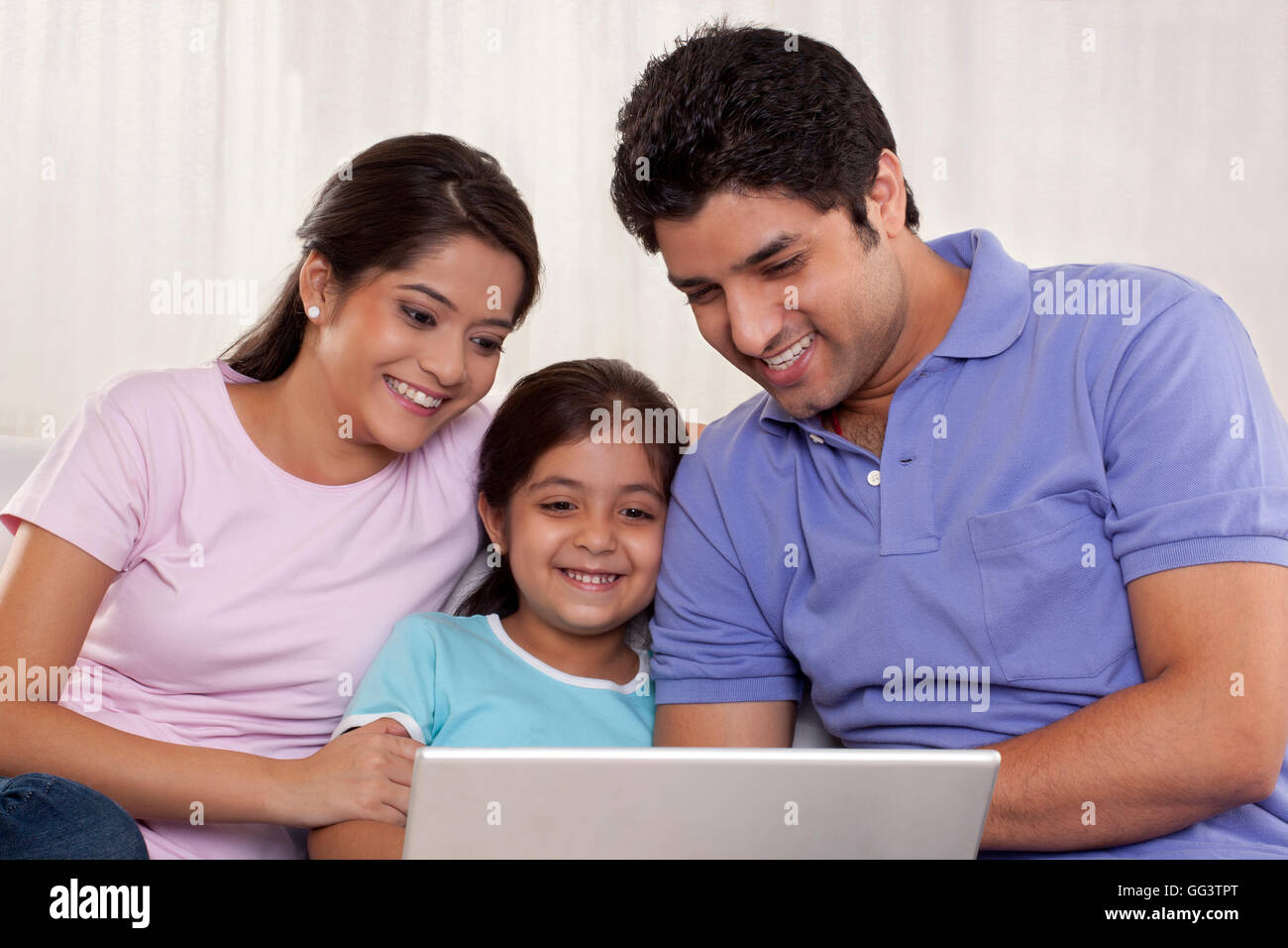 Happy family using laptop Stock Photo - Alamy