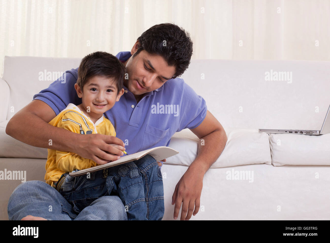 Father helping his son in drawing at home Stock Photo - Alamy