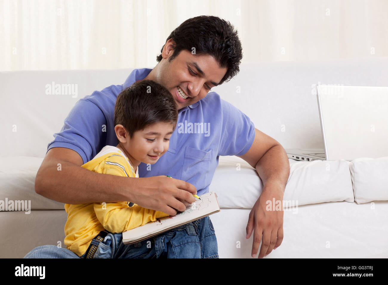 Happy father helping his son in drawing at home Stock Photo - Alamy