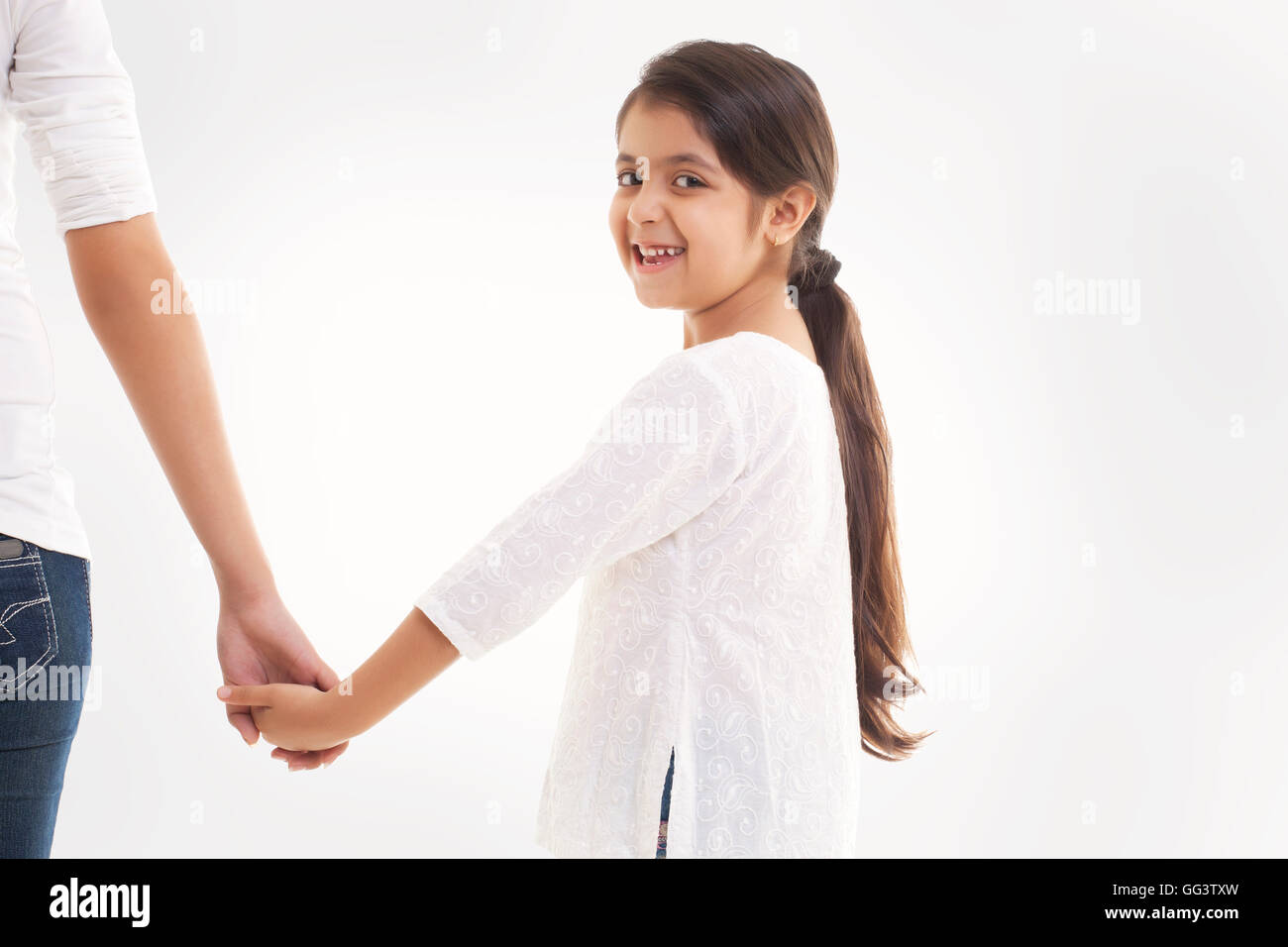 Portrait of little girl holding mother's hand Stock Photo - Alamy