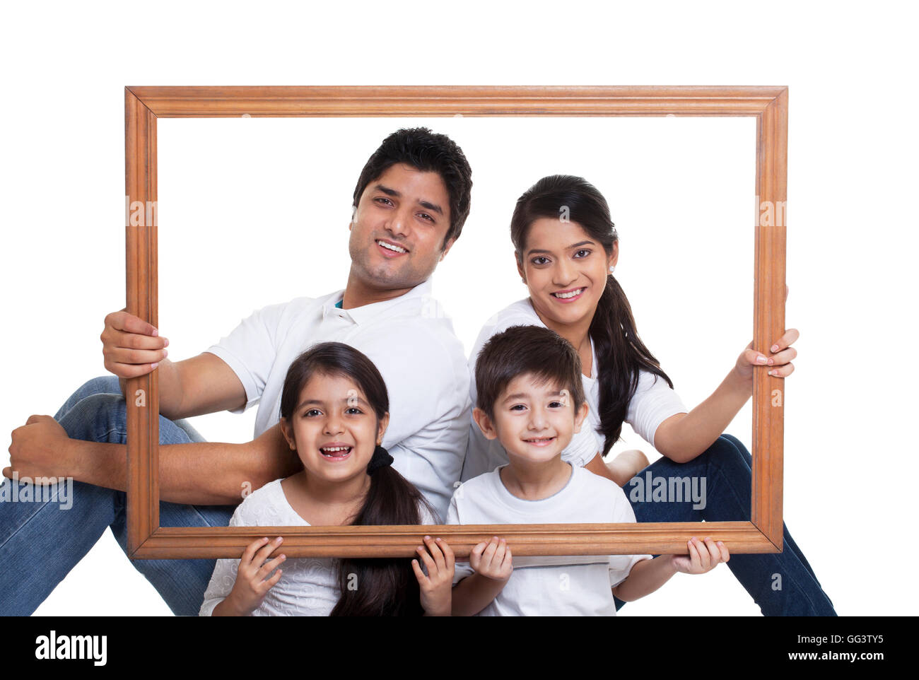 Portrait of happy family holding frame Stock Photo - Alamy