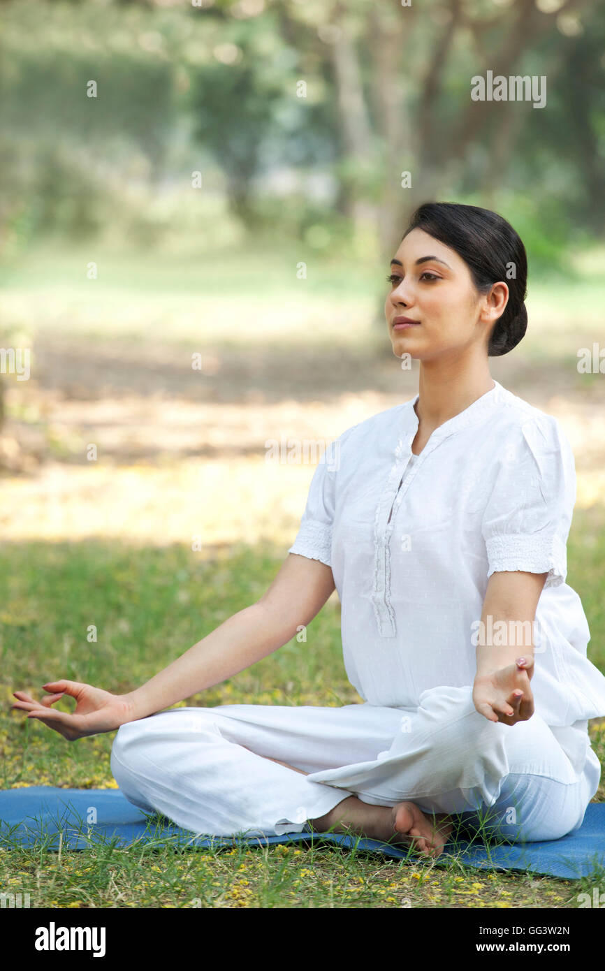 Young woman sitting in lotus position Stock Photo - Alamy