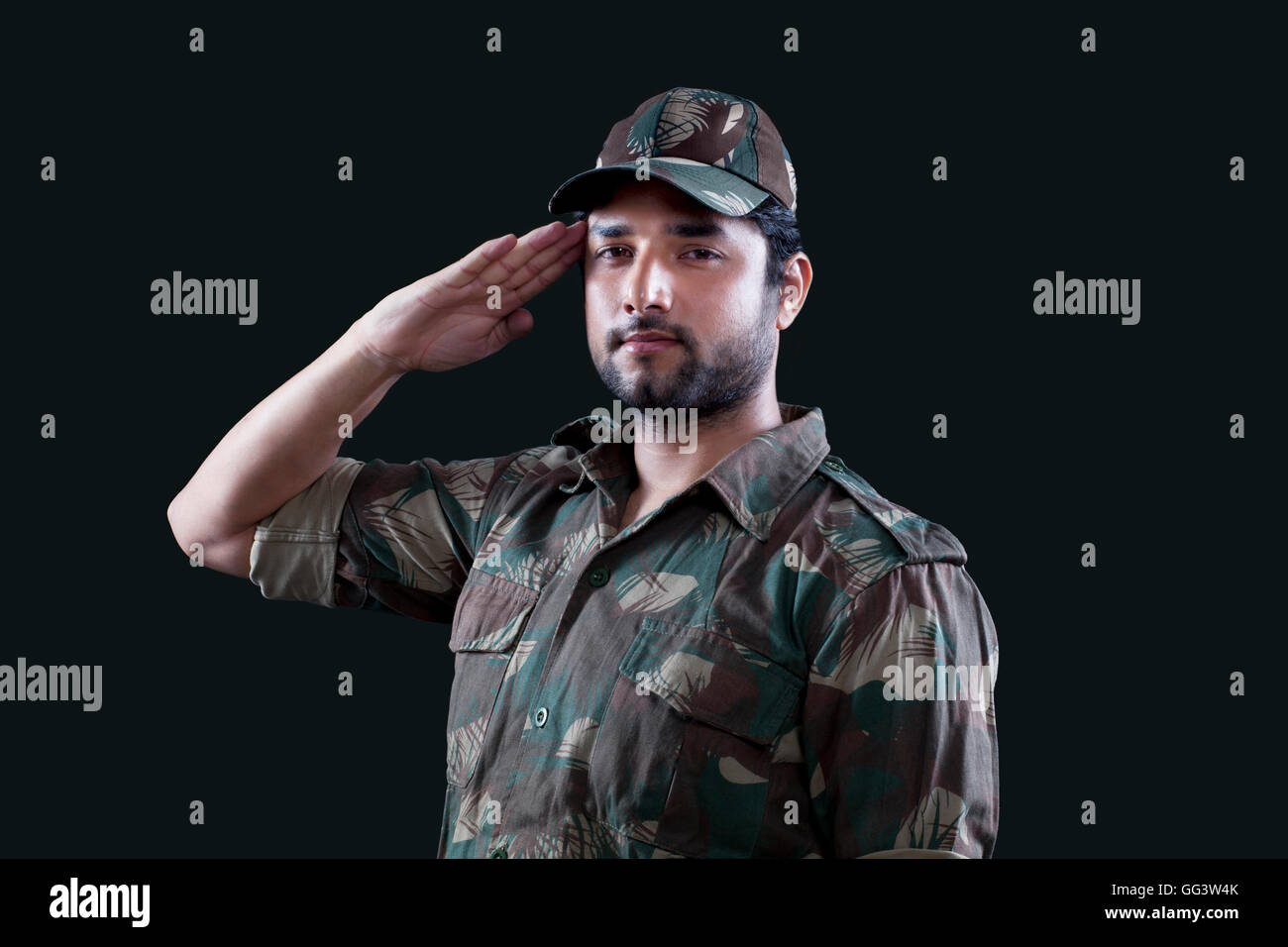Portrait of young male soldier saluting Stock Photo - Alamy