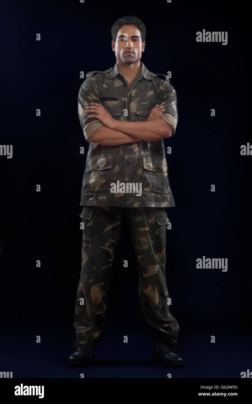 Handsome soldier with arms folded Stock Photo - Alamy