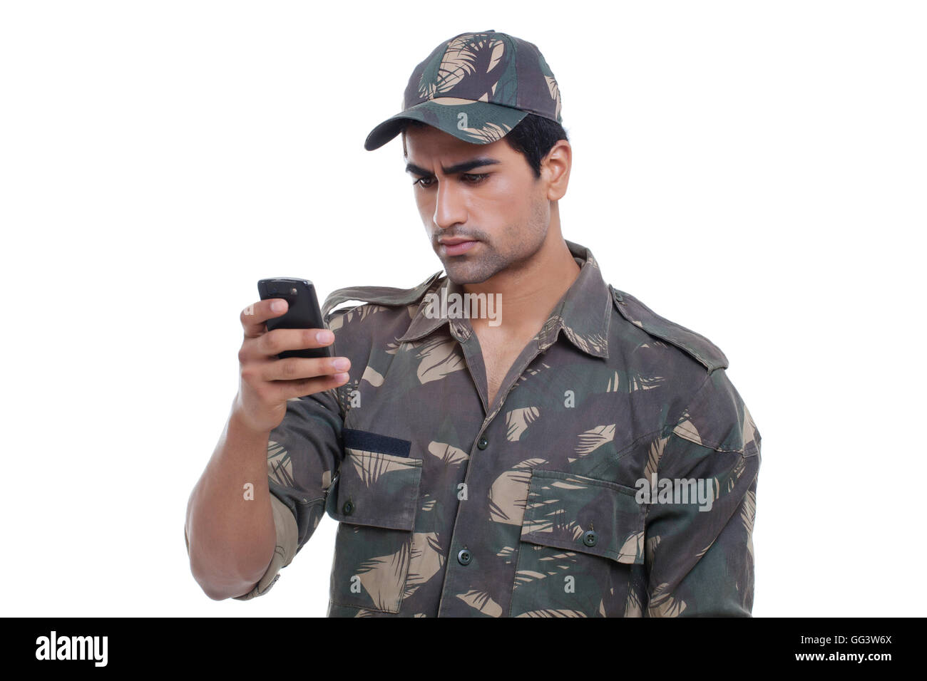 Serious young soldier reading message on his cell phone Stock Photo - Alamy