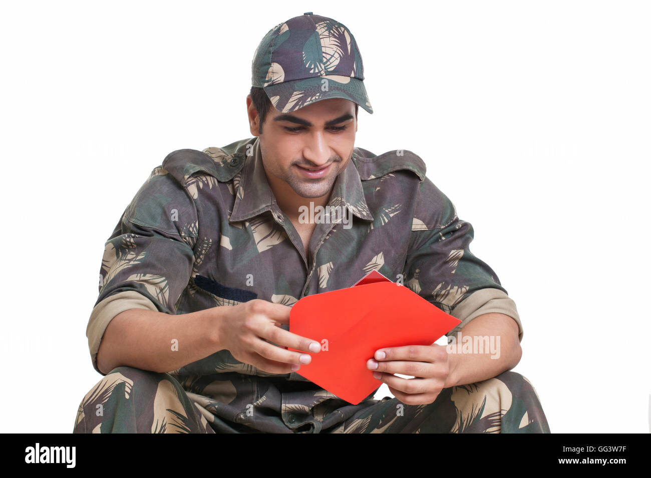 Male soldier holding greeting card over white background Stock Photo ...