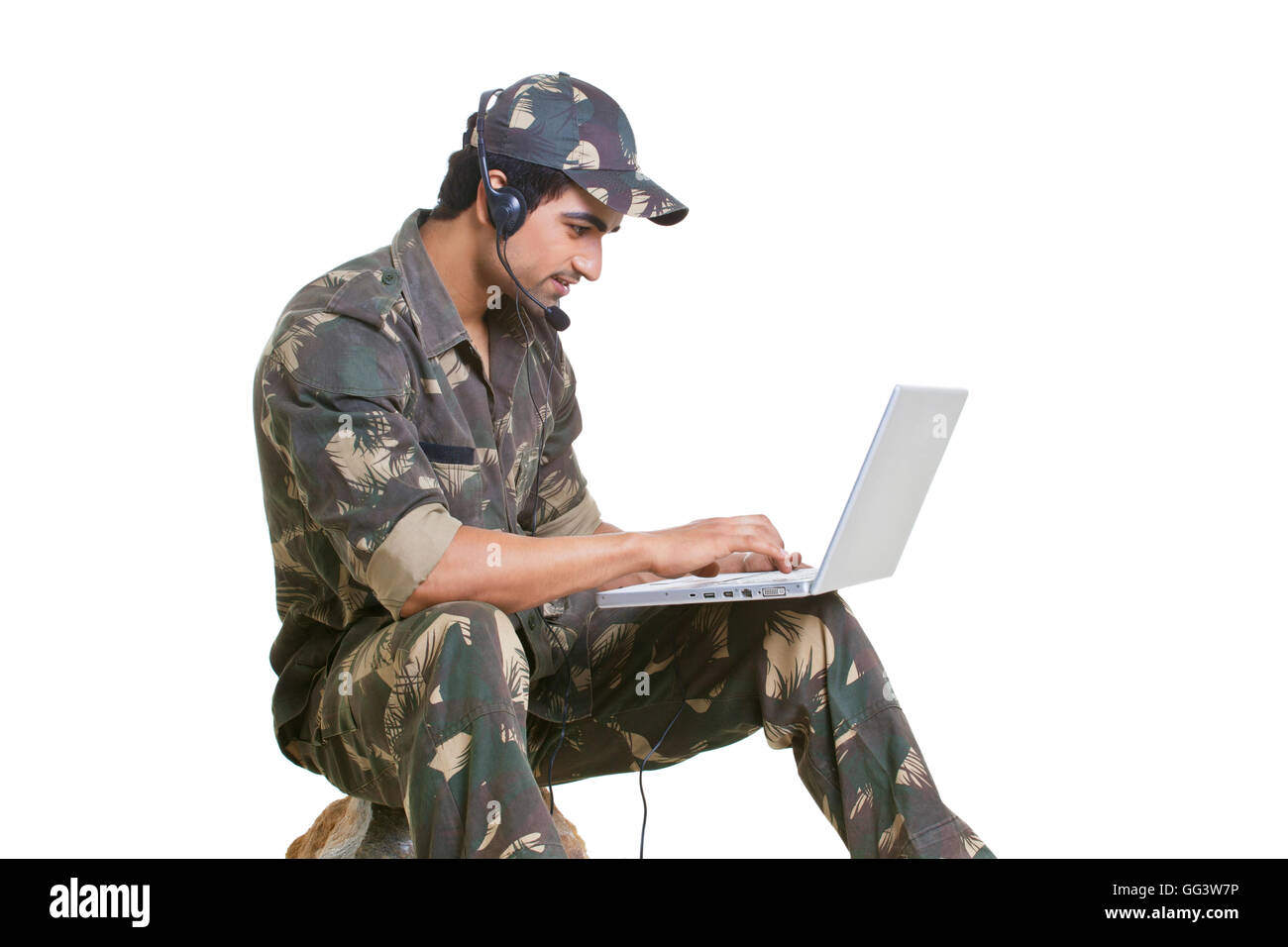 Young soldier using laptop over white background Stock Photo - Alamy