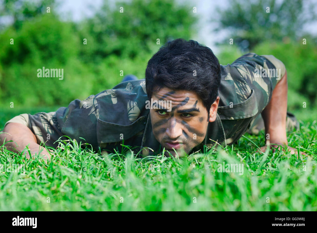 Soldier trying to hide during war Stock Photo - Alamy