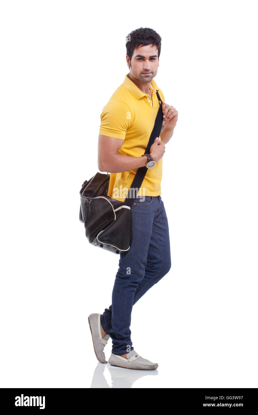 Portrait of handsome young man with duffel bag Stock Photo - Alamy