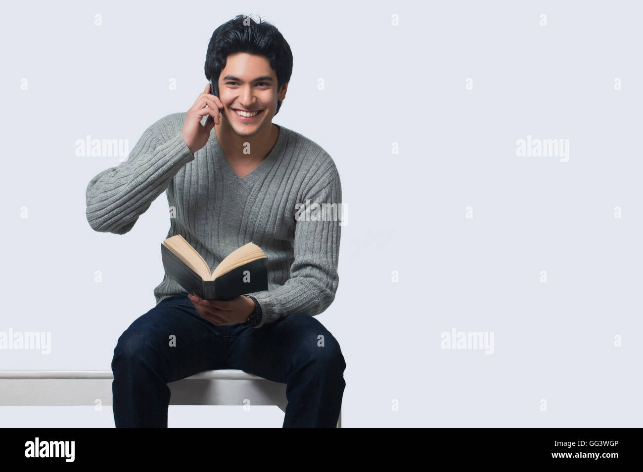 Man smiling holding book hi-res stock photography and images - Alamy