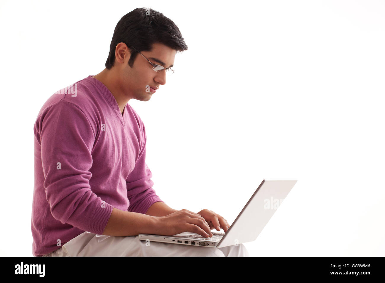 Young man typing on laptop Stock Photo - Alamy