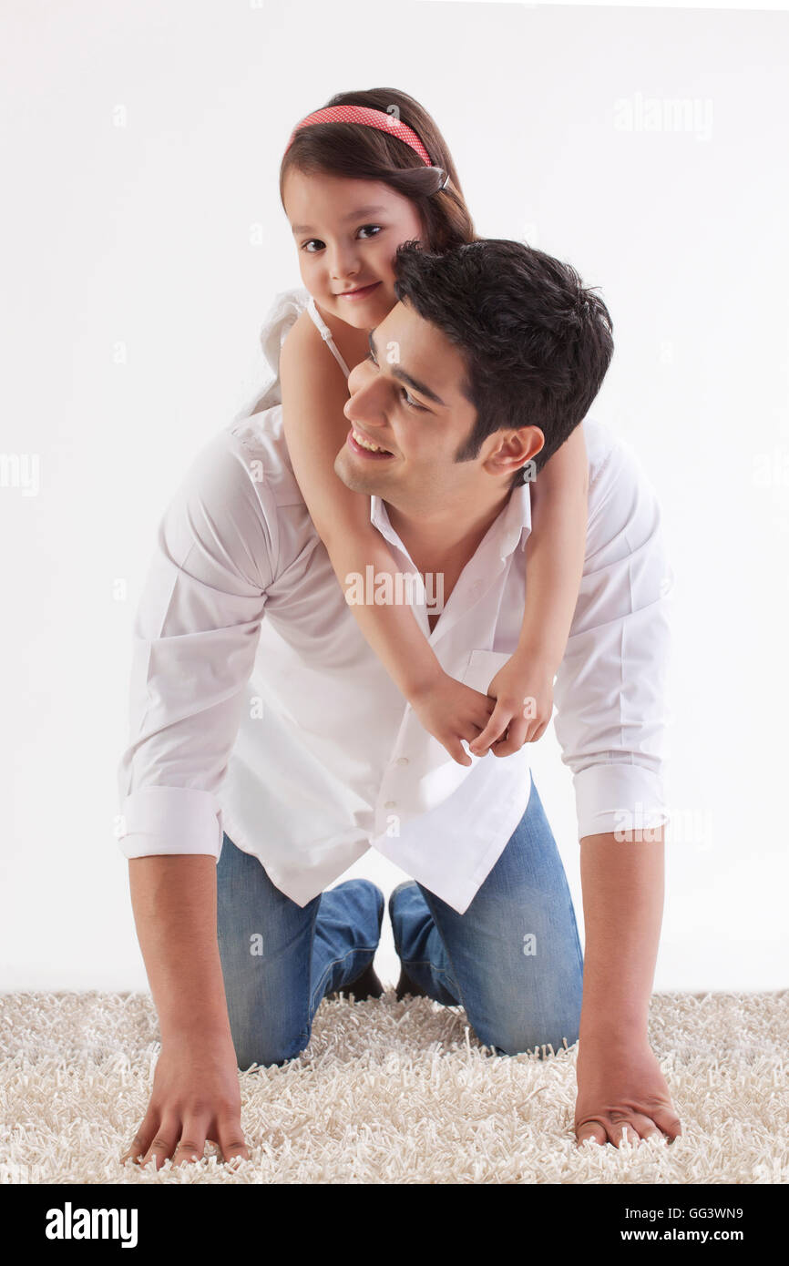 Portrait of a smiling daughter sitting on her father's back Stock Photo ...