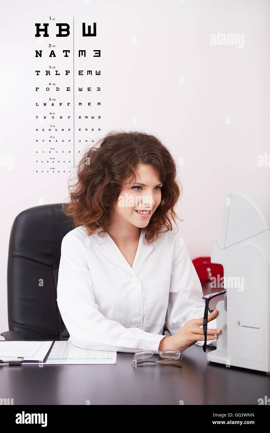 pretty young optometrist at work, examinating your eyes Stock Photo - Alamy