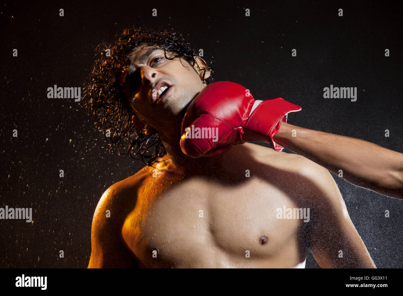 Handsome male boxer striking opponent Stock Photo - Alamy