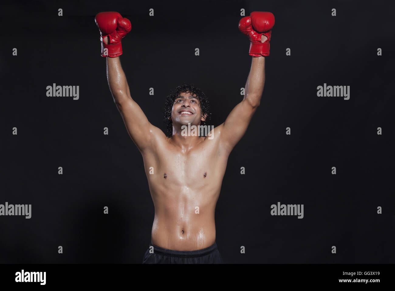 Male boxer celebrating victory on black background Stock Photo - Alamy