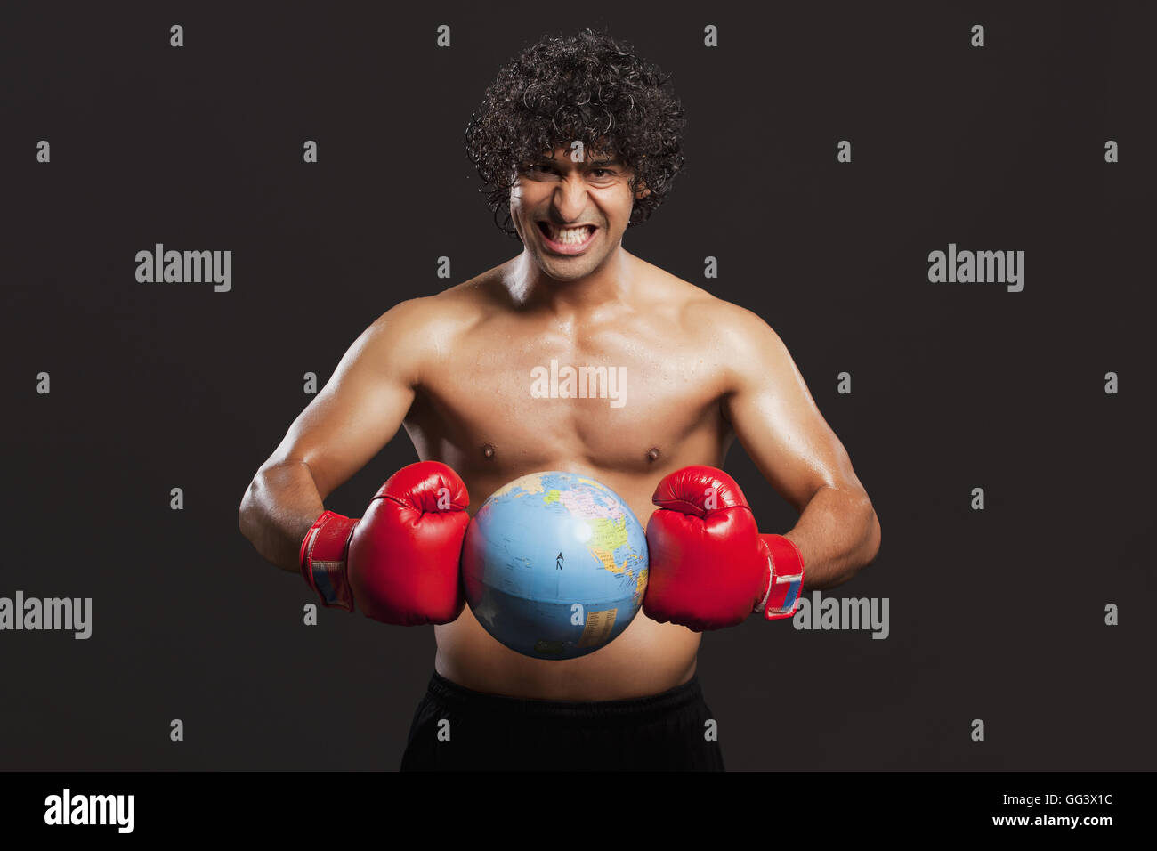 Young boxer breaking globe Stock Photo - Alamy