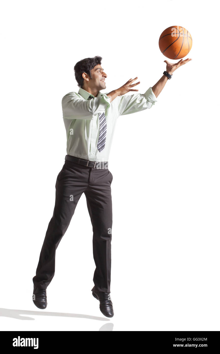 Young man catching basket ball Stock Photo - Alamy